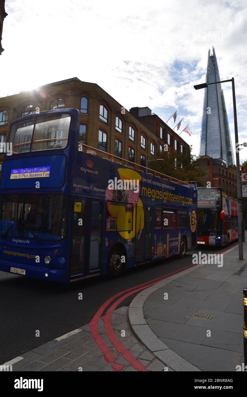 A megasightseeing London tour bus with the Shard in the background ...