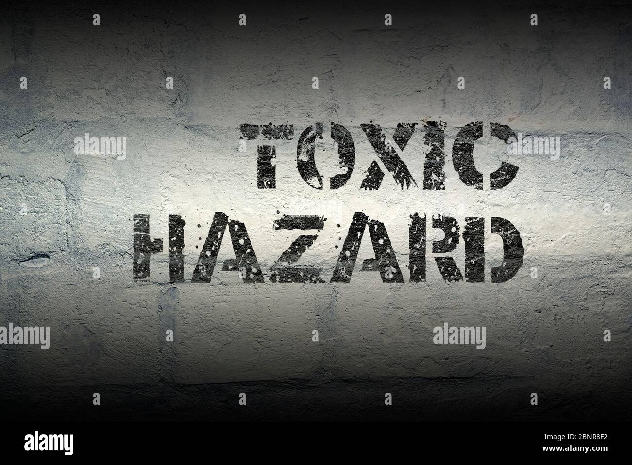 toxic hazard stencil print on the grunge white brick wall Stock Photo ...