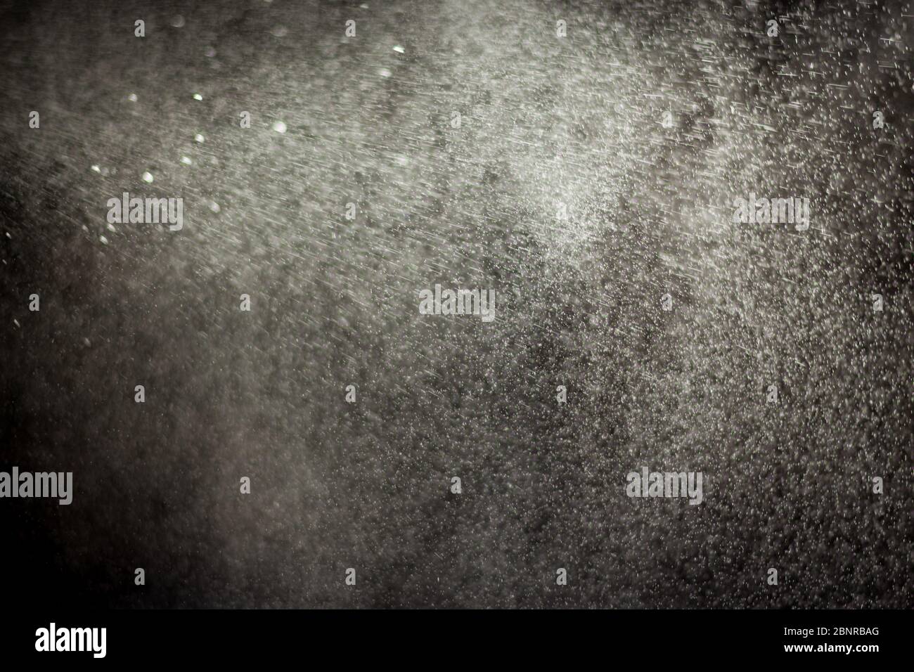 water spray from bottle. close up of a spraying water drops isolated on ...