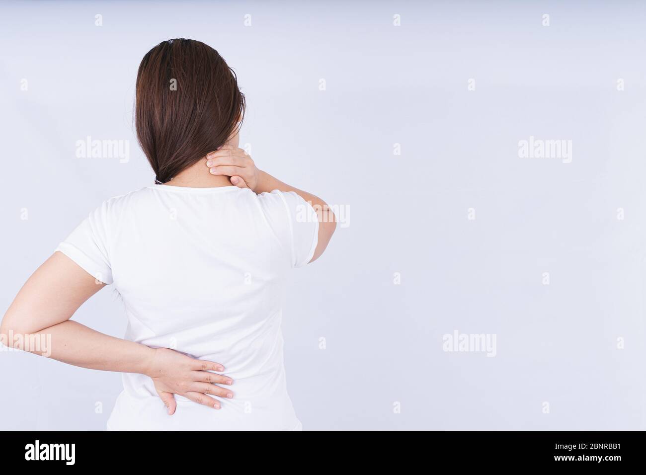 Female touching acute neck and lower back pain on white background with ...