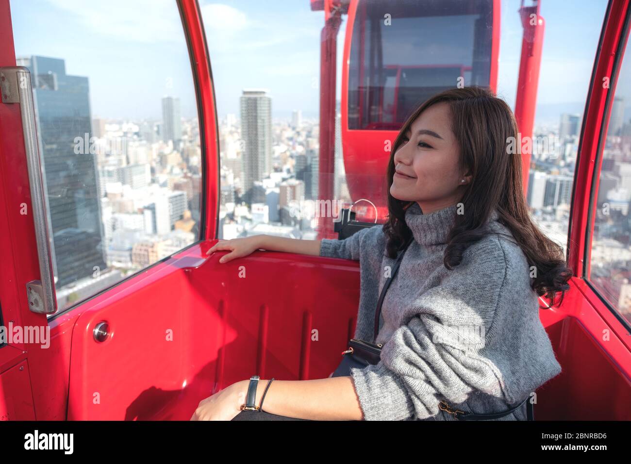 A beautiful asian woman riding a red ferris wheel in Japan Stock Photo ...