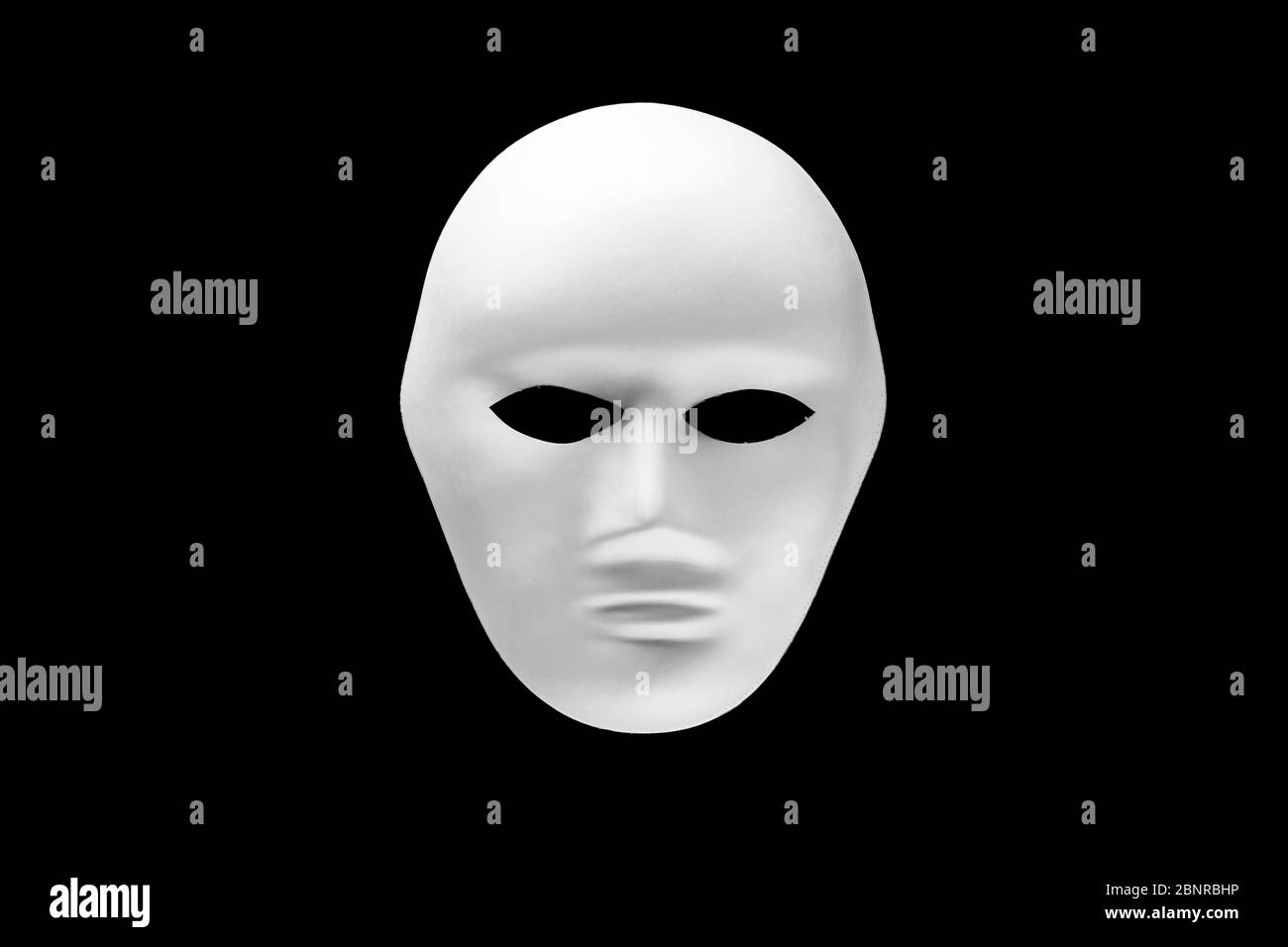 White human face mask isolated on black background Stock Photo - Alamy
