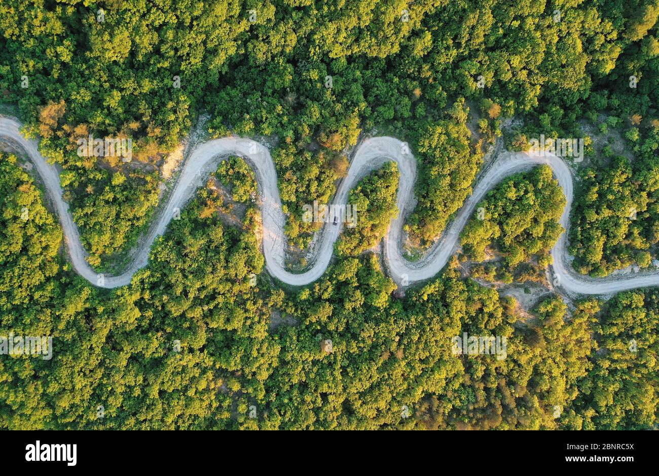 Road trip, car going through a curve road. Aerial point of view Stock ...