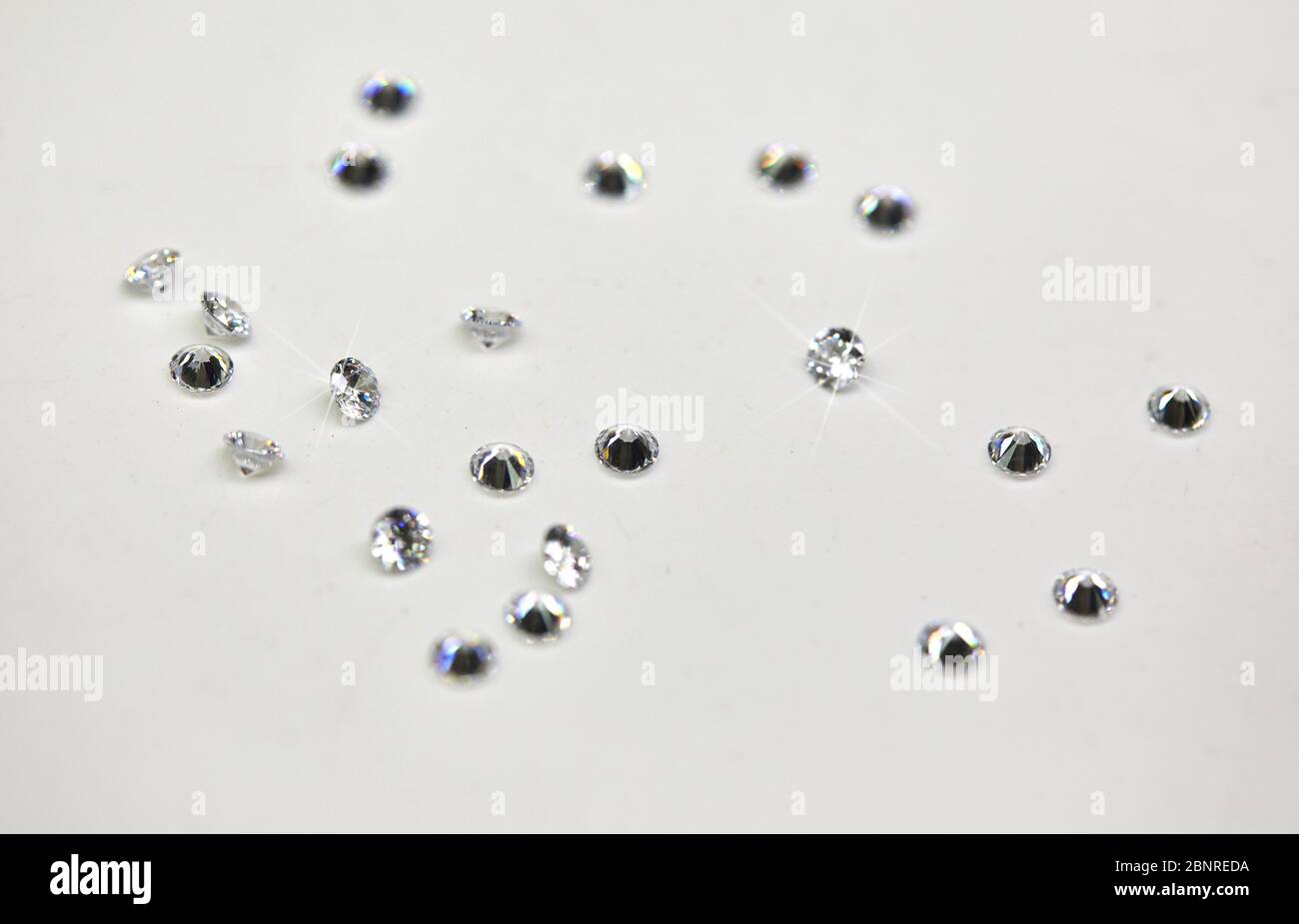 Jewelry production. Scattered diamonds on white background Stock Photo ...