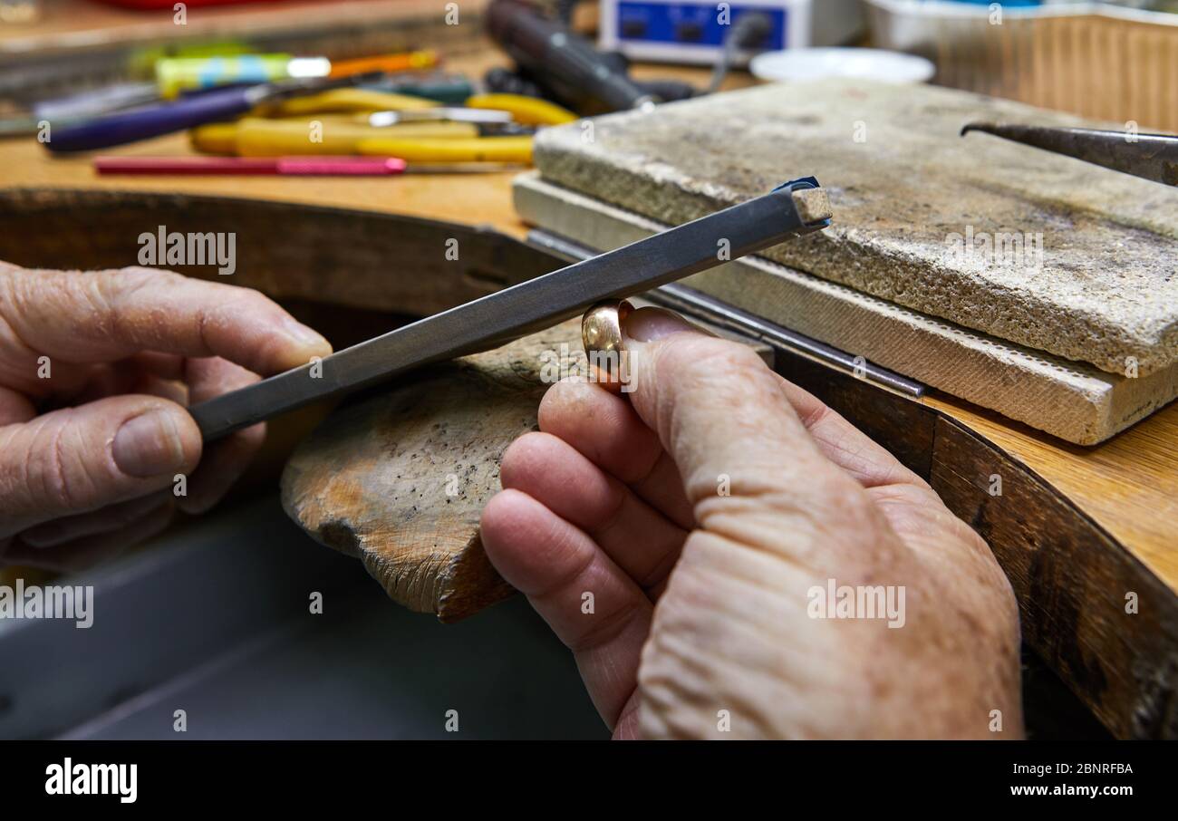 Jewelry production. The jeweler makes a gold ring. The process of ...