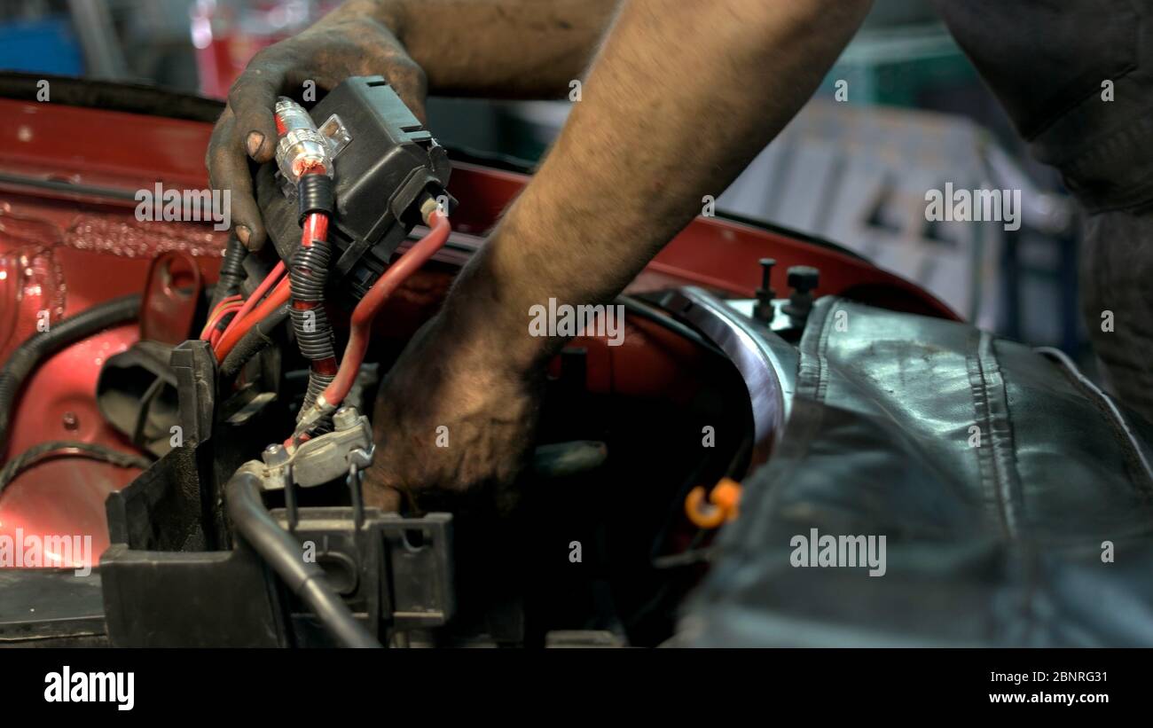 Mechanic screwing car engine mechanism Stock Photo - Alamy