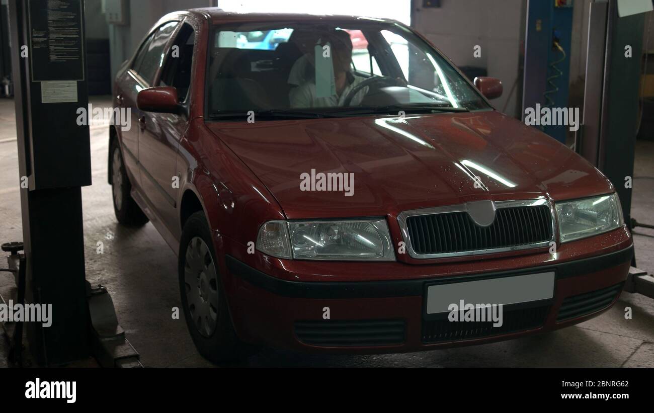 Red car in a car service garage Stock Photo - Alamy
