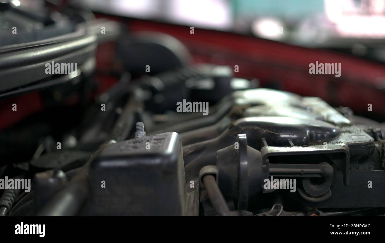 Mechanic is unscrewing car engine detail Stock Photo - Alamy