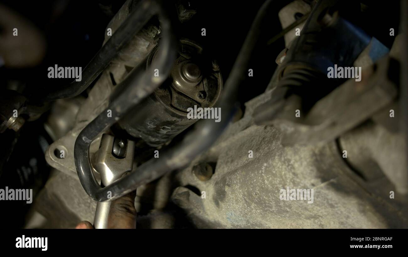 Installing crankcase protection by two auto mechanics Stock Photo - Alamy