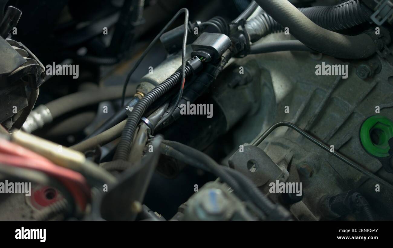 Close up male hand fixing car engine Stock Photo - Alamy