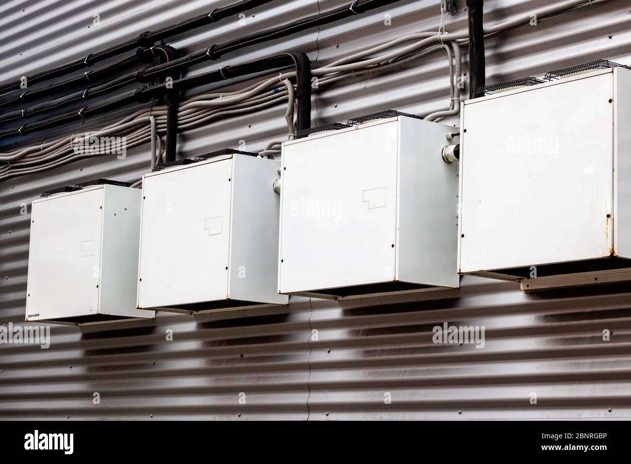 Metal boxes on the wall of a building close up Stock Photo - Alamy