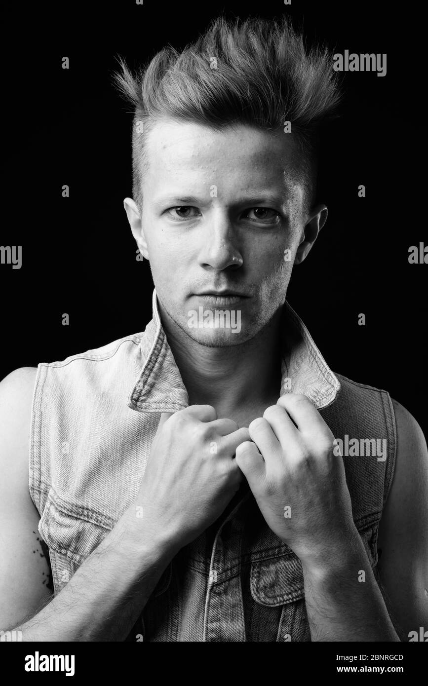 Punk rocker man against black background in black and white Stock Photo ...