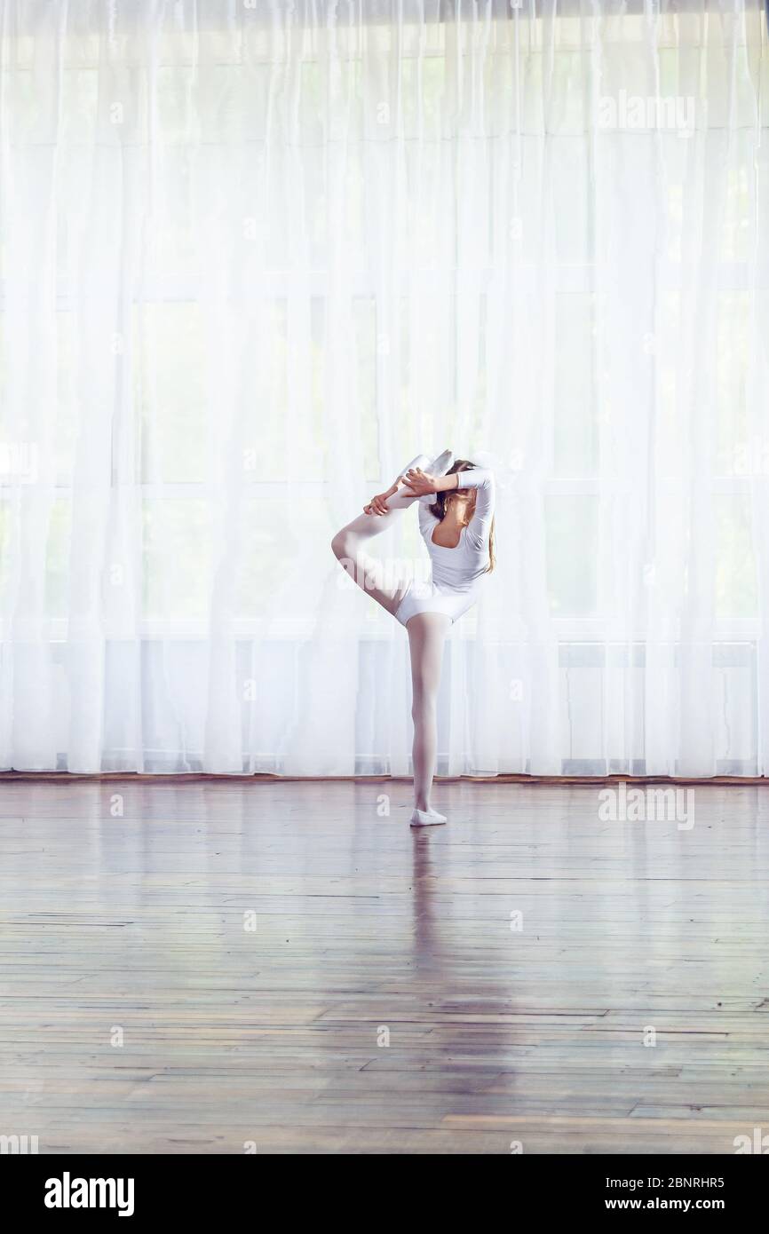 gymnast girl stands on one leg Stock Photo - Alamy