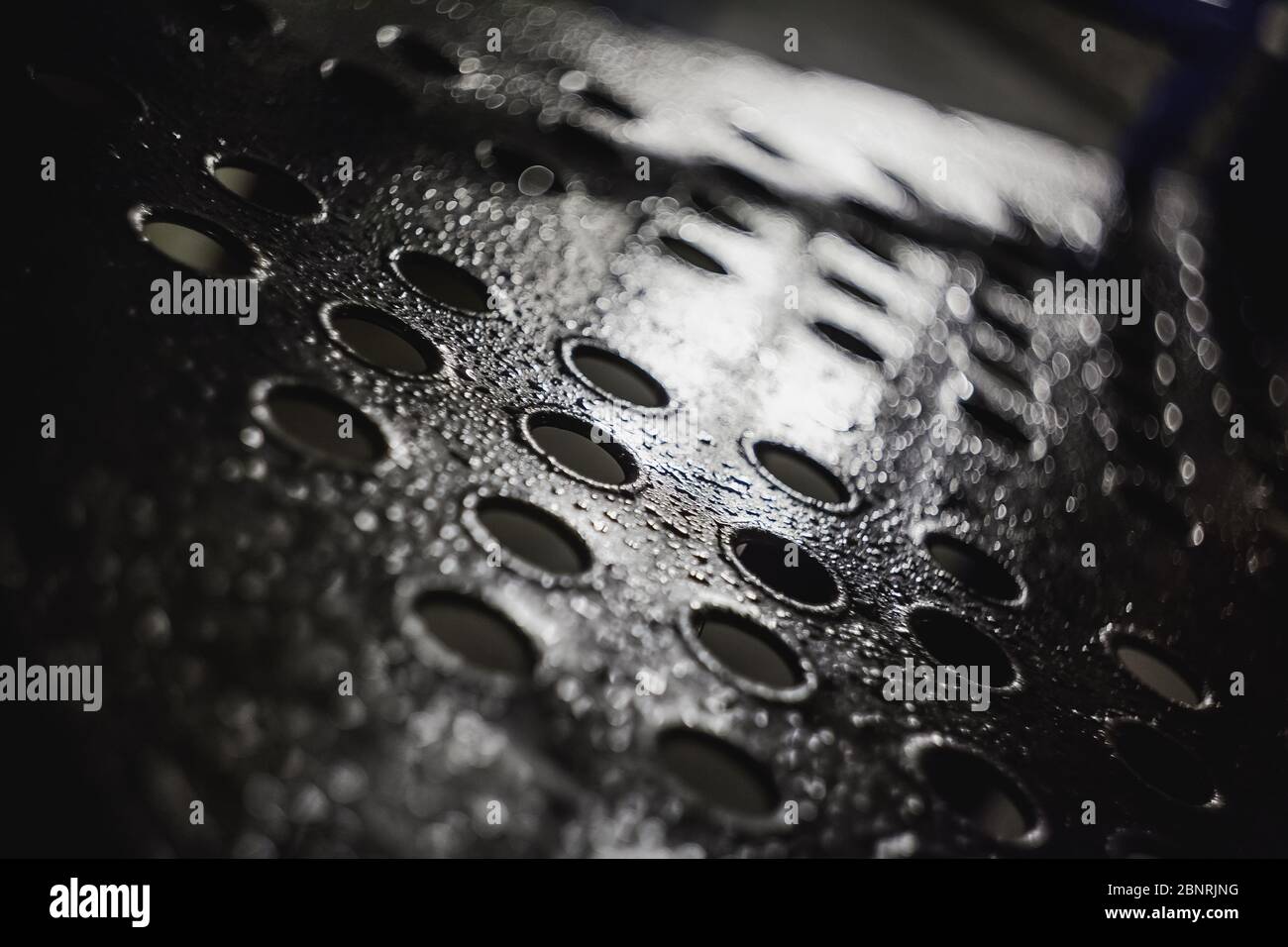 wet metal surface with some holes Stock Photo - Alamy