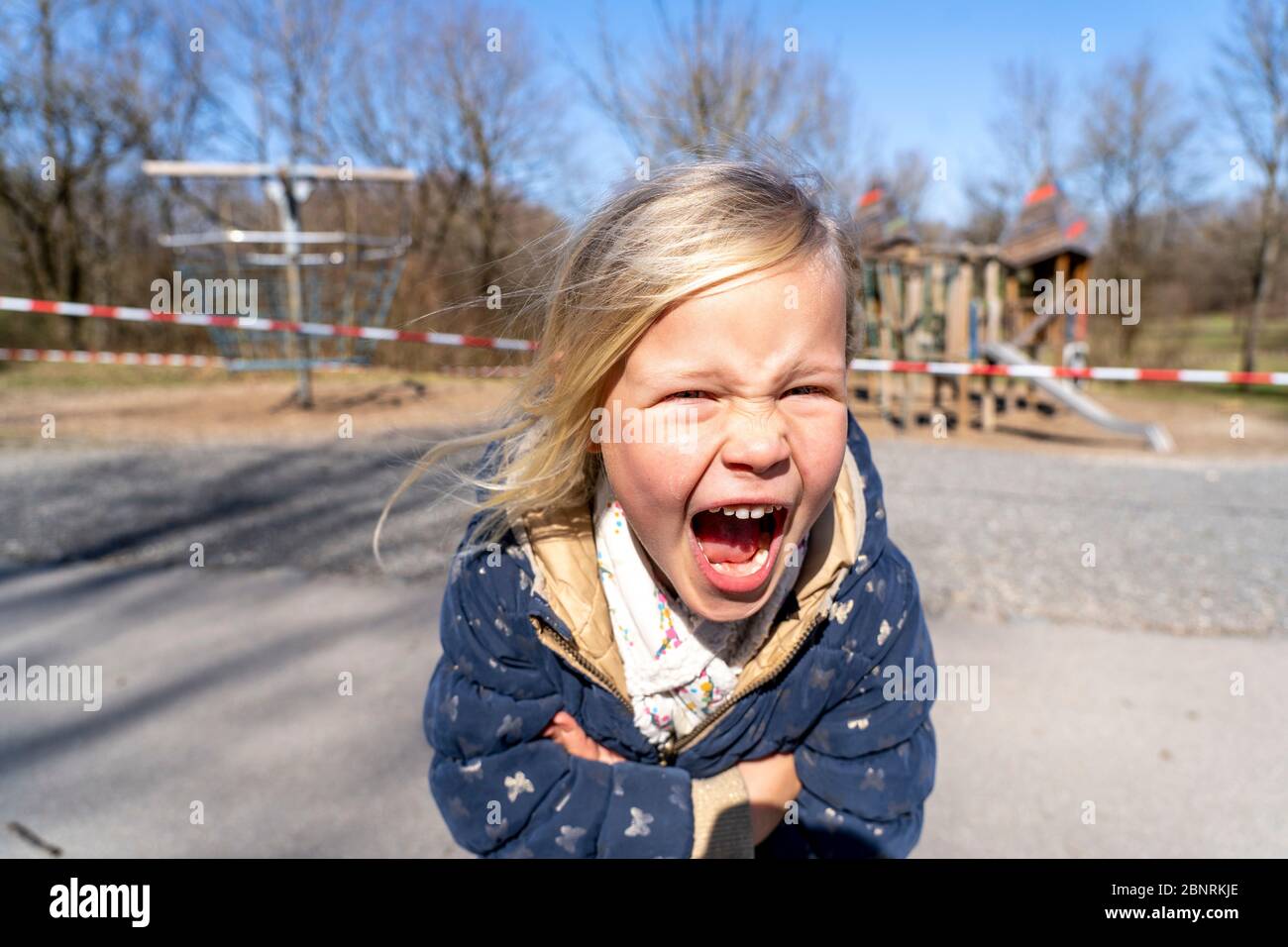 Child standing alone in playground hi-res stock photography and images ...