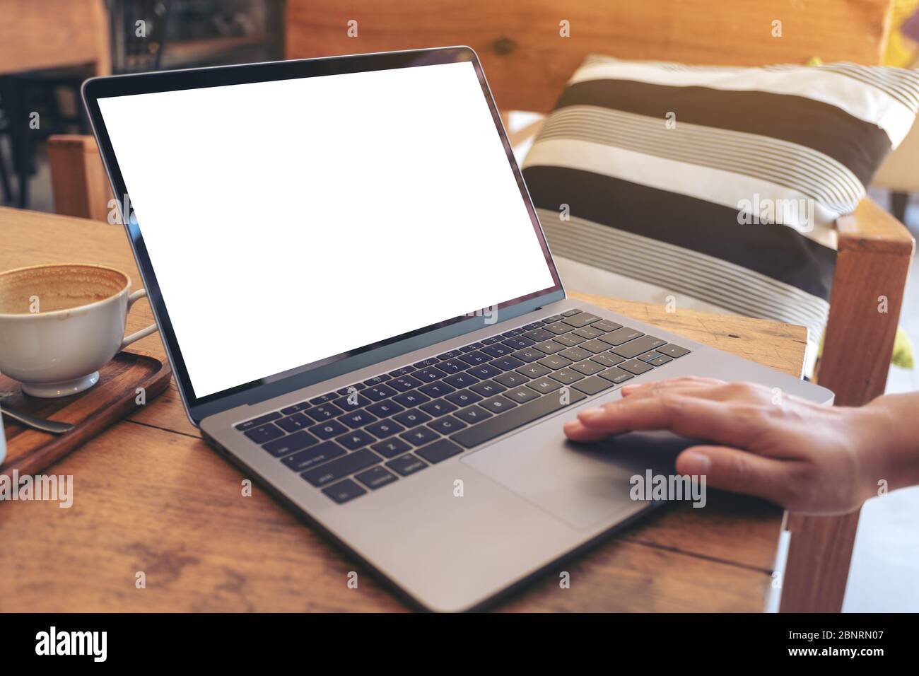 Closeup image of hand using and touching on mockup laptop touchpad on ...