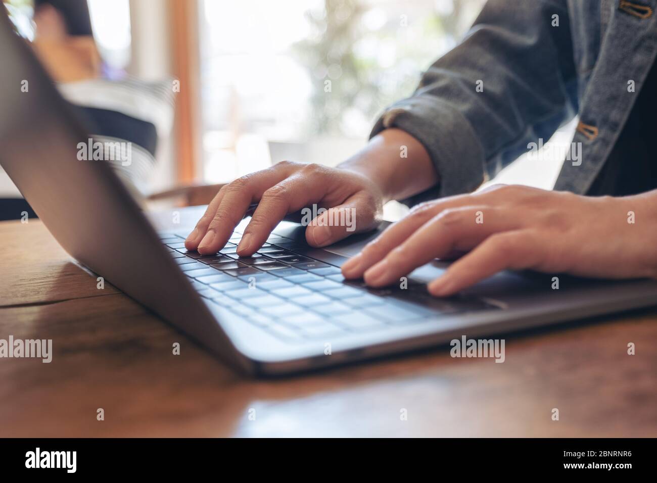 Closeup image of woman's hands using and typing on laptop keyboard on ...