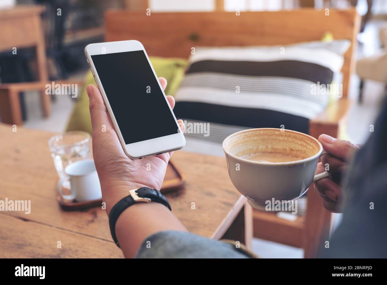 Mockup image of hands holding white mobile phone with blank screen ...