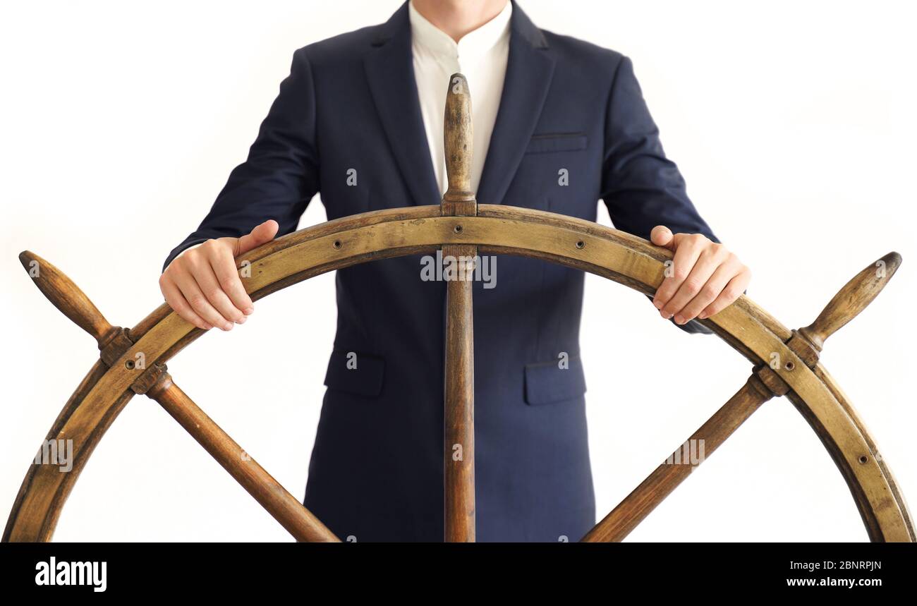 Businessman holding ship rudder Stock Photo - Alamy