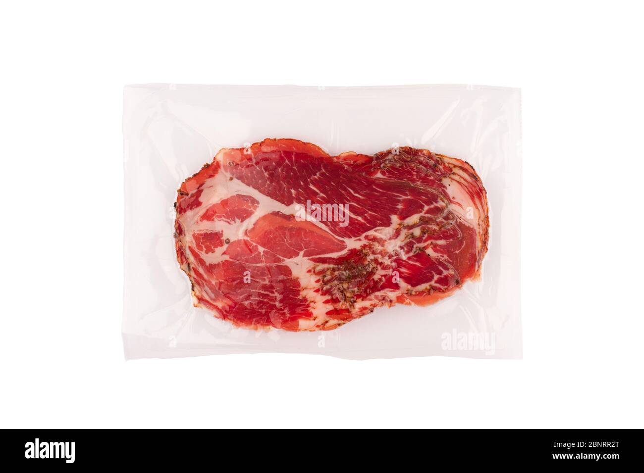 top view of slices of smoked pork loin ham in transparent plastic ...