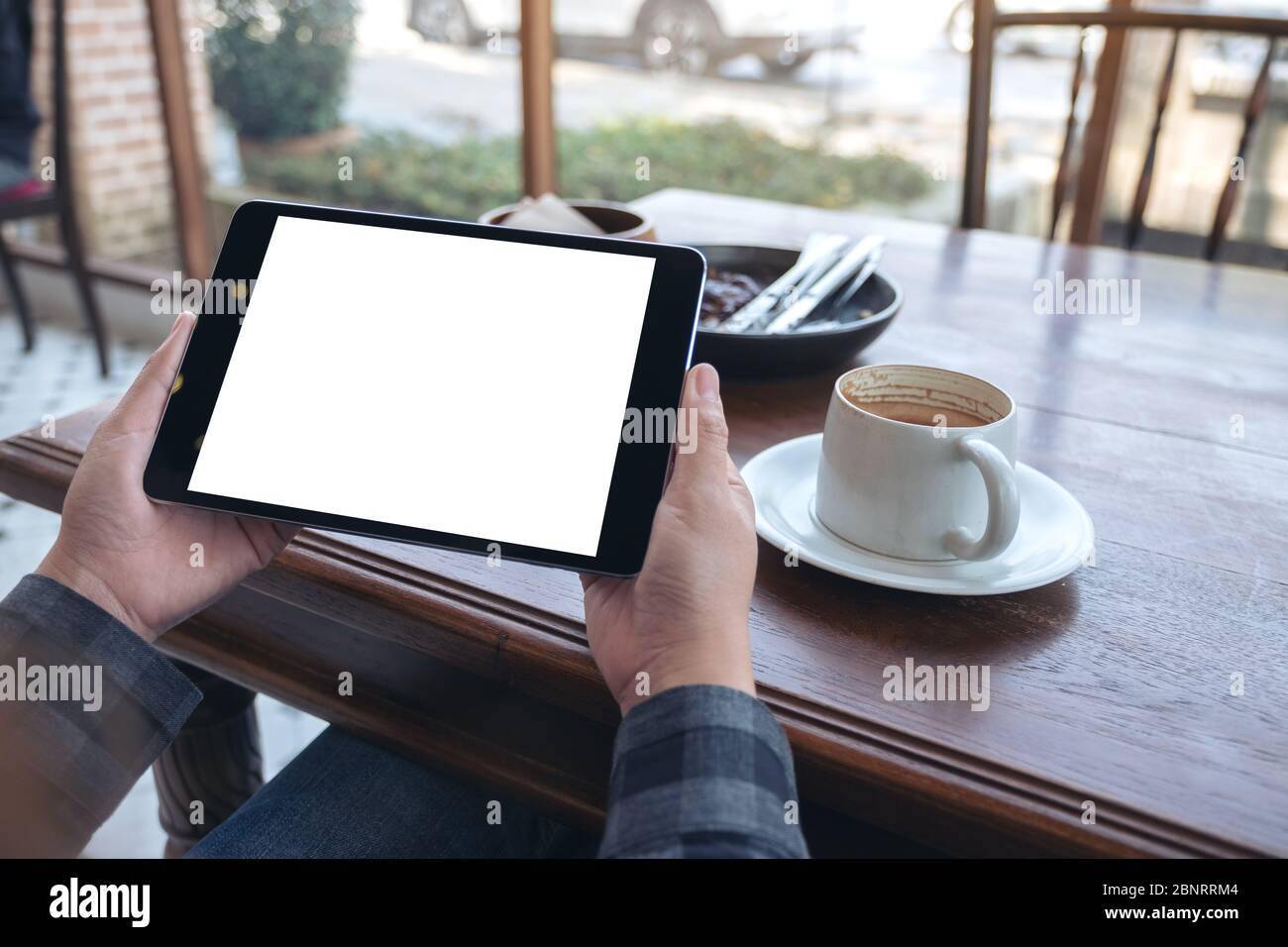 Mockup image of woman's hands holding black tablet pc with blank screen ...