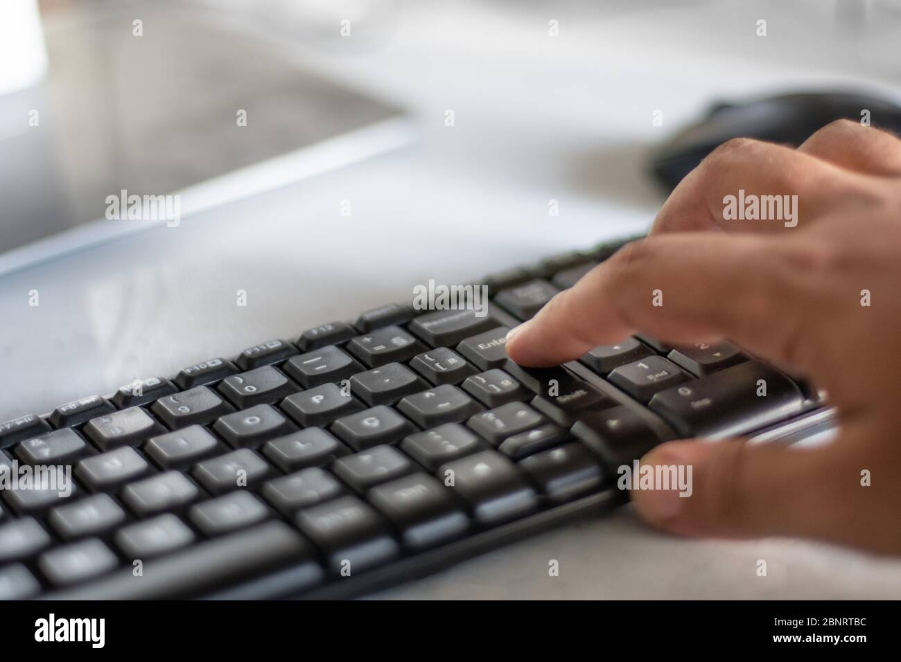 Finger on the enter key - hand pressing "enter" button on computer ...