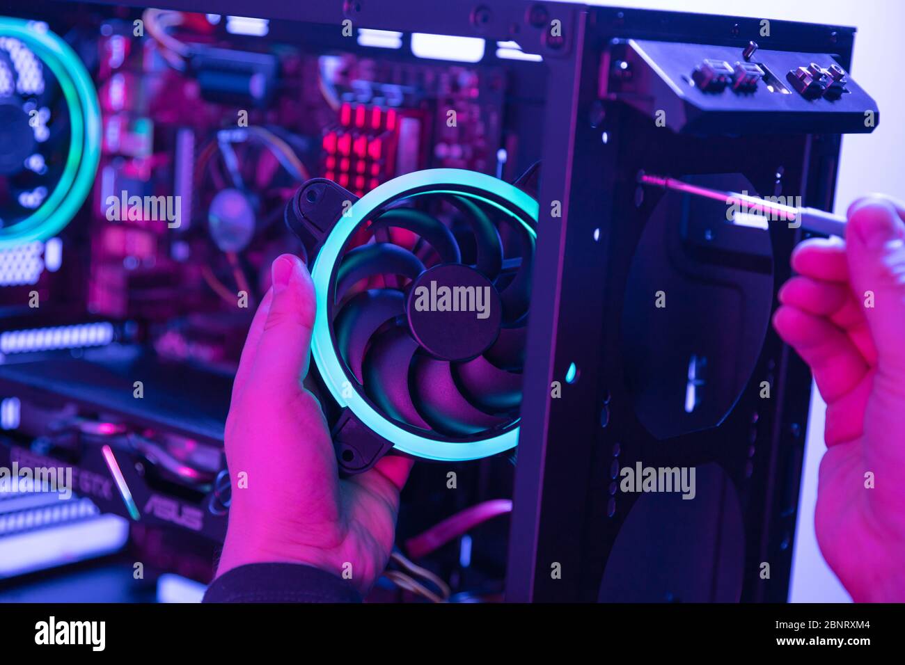 Man puts modern fan with blue led light in the computer using ...