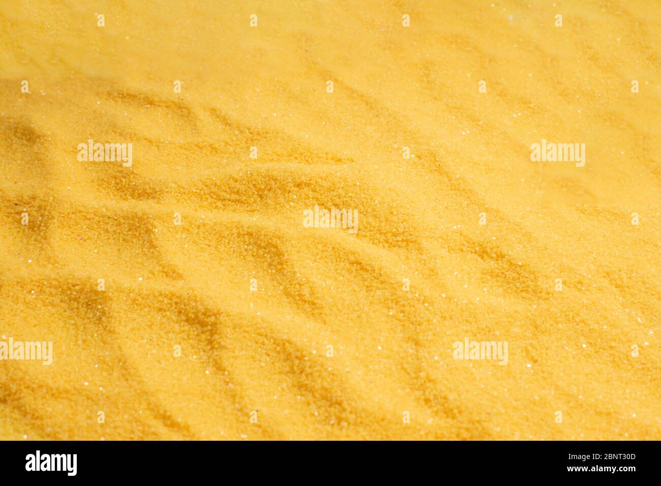 Yellow sand texture and background Stock Photo - Alamy