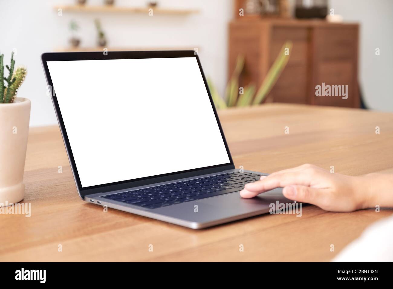 Mockup image of hands using and touching on laptop touchpad with blank ...