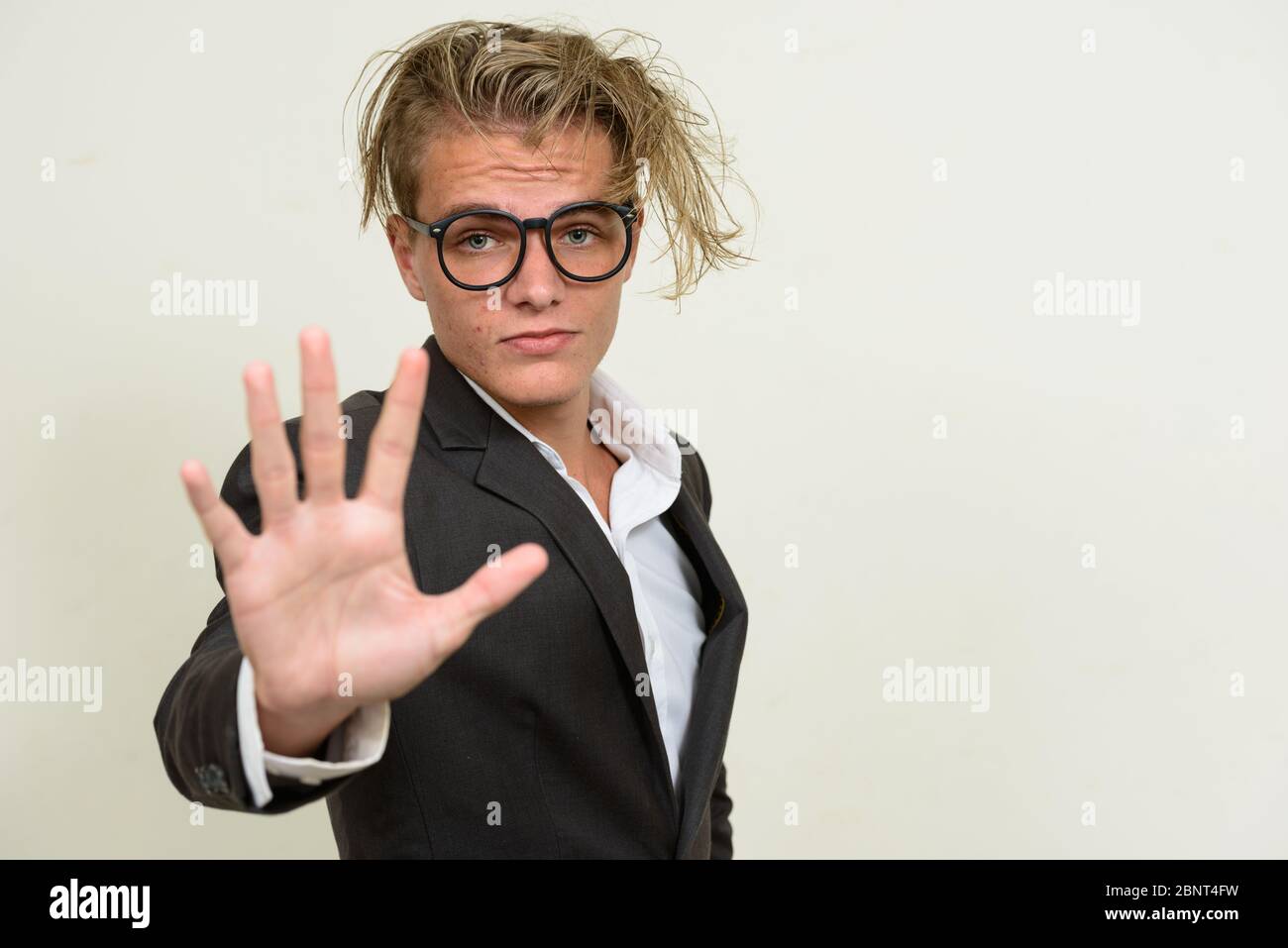 Young blond businessman with eyeglasses showing stop gesture Stock ...