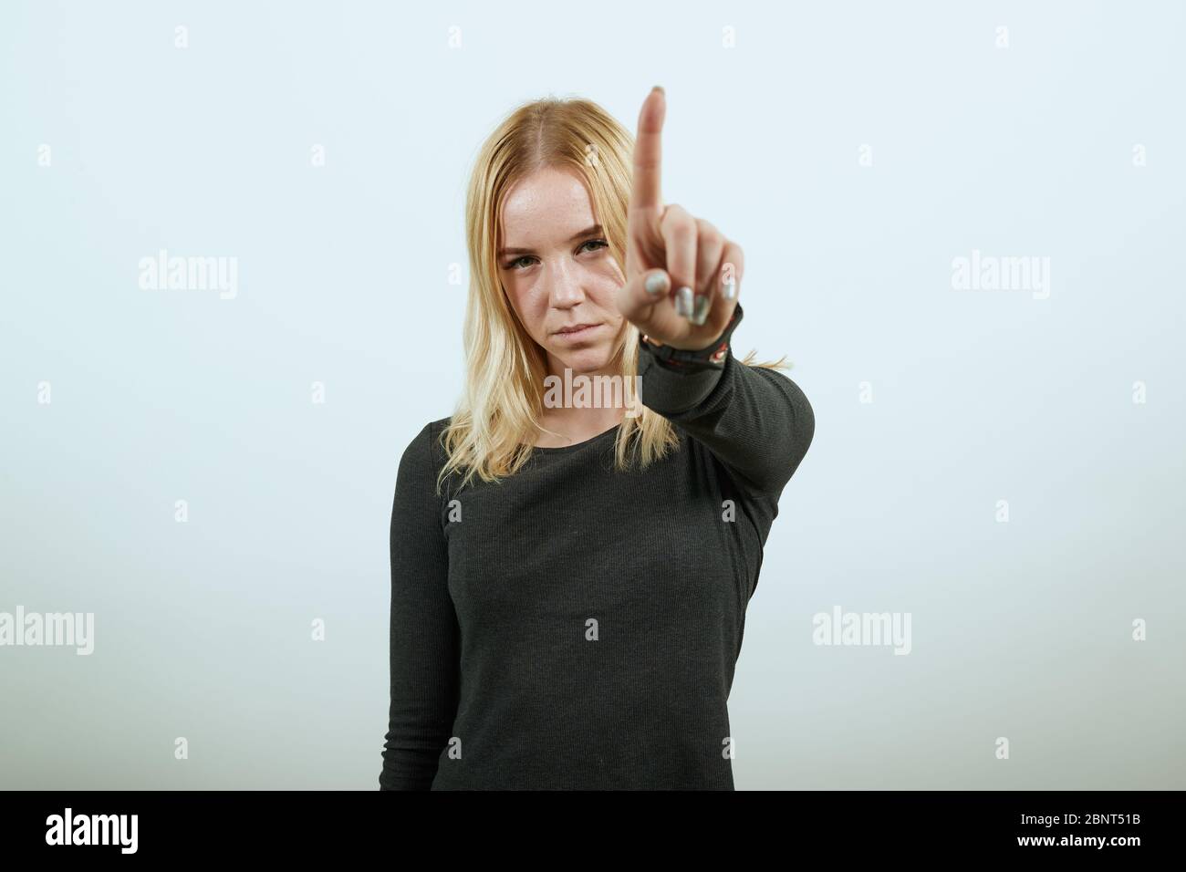 Dissatisfied Girl Protests, Held Forefinger Up With A Nervous ...