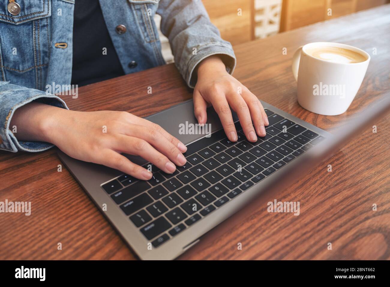 Closeup image of woman's hands using and typing on laptop keyboard on ...