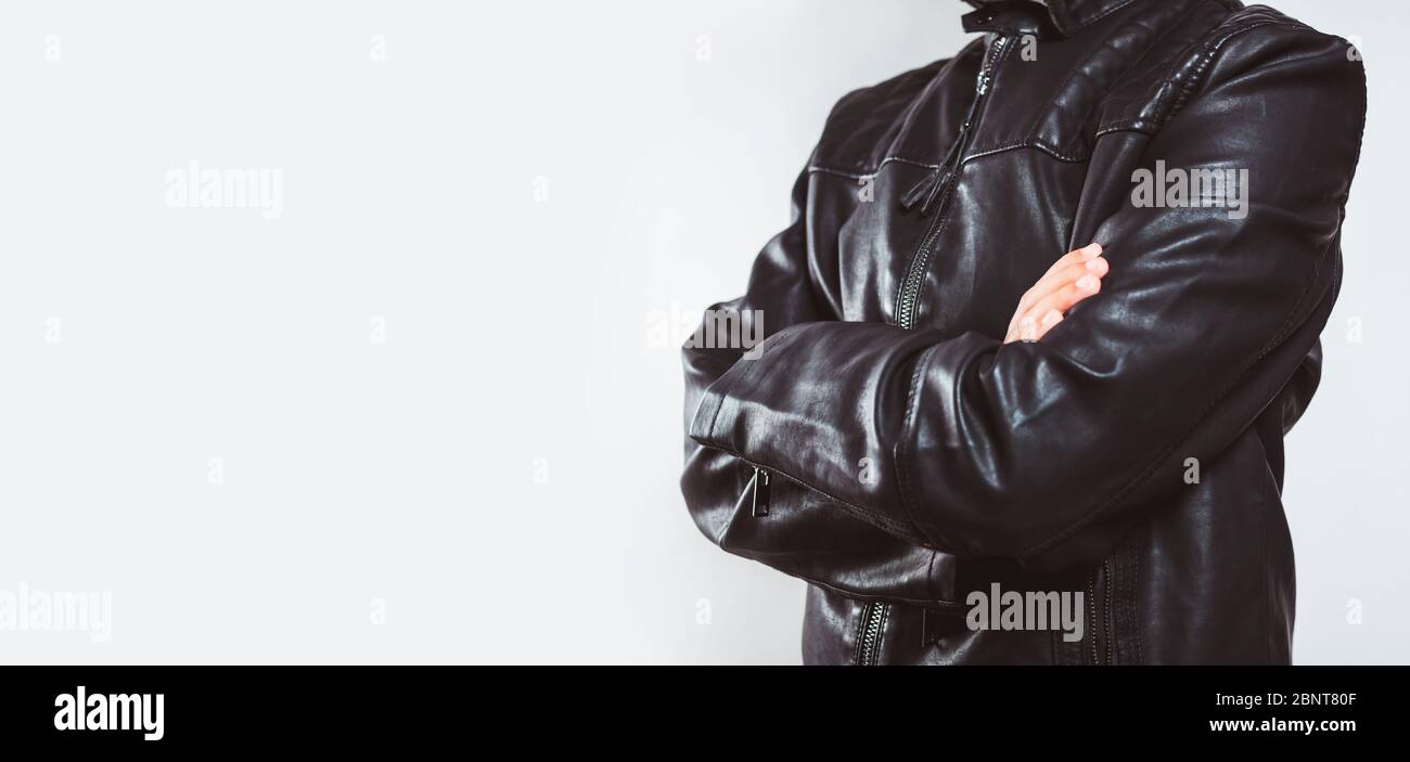 view of a young man with a leather jacket and crossing arms against ...