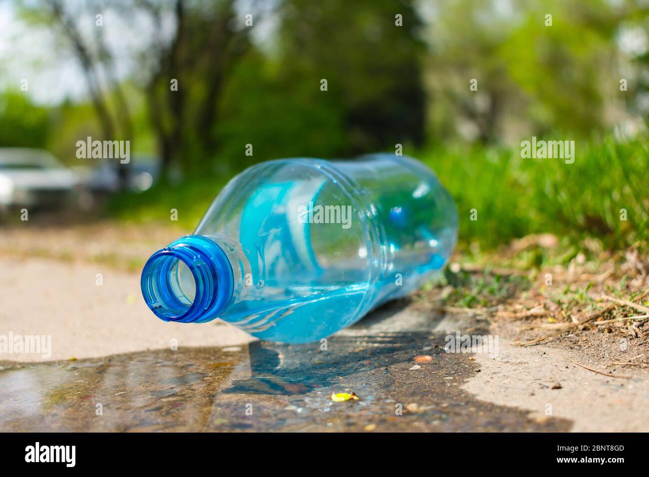 Environmental pollution by plastic bottles. A plastic bottle lies on ...