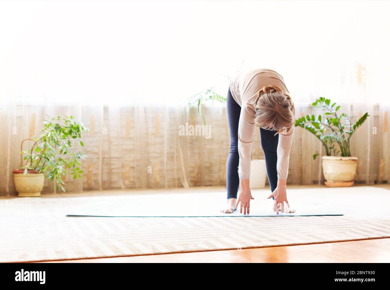 Full body adult female in casual clothes raising arms and stretching ...