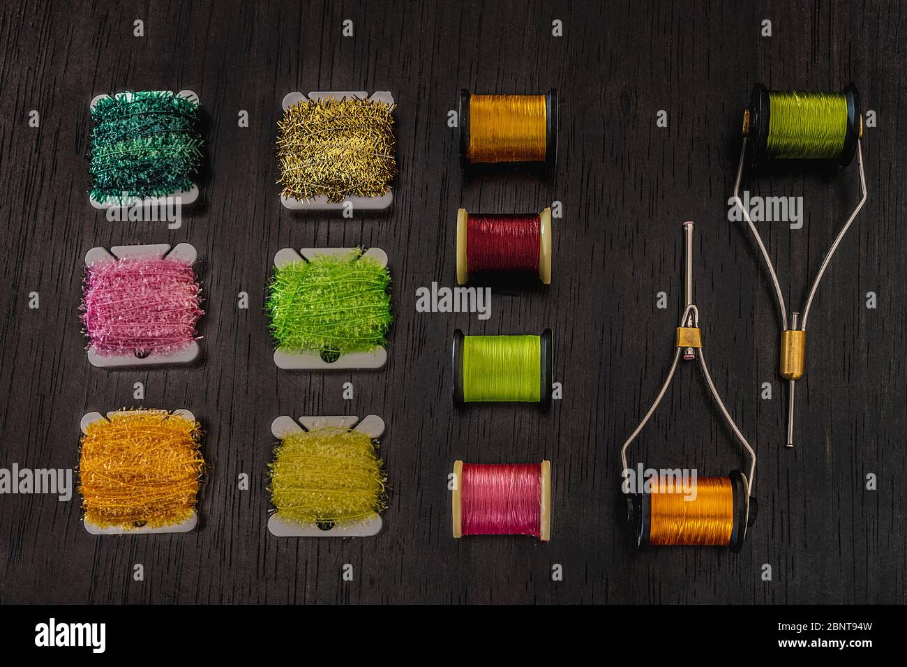 several spools of thread of various types and colours for tying flies ...