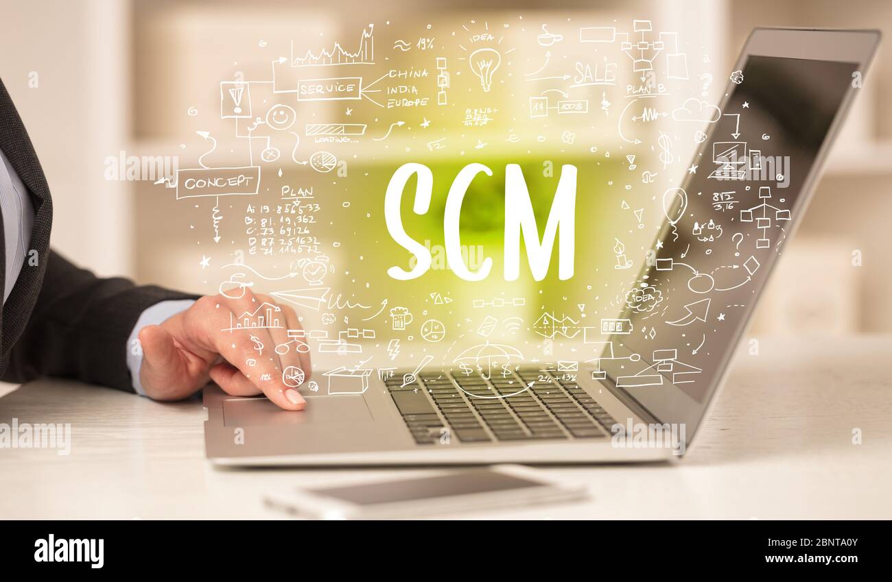 hand working on new modern computer with SCM abbreviation, modern ...