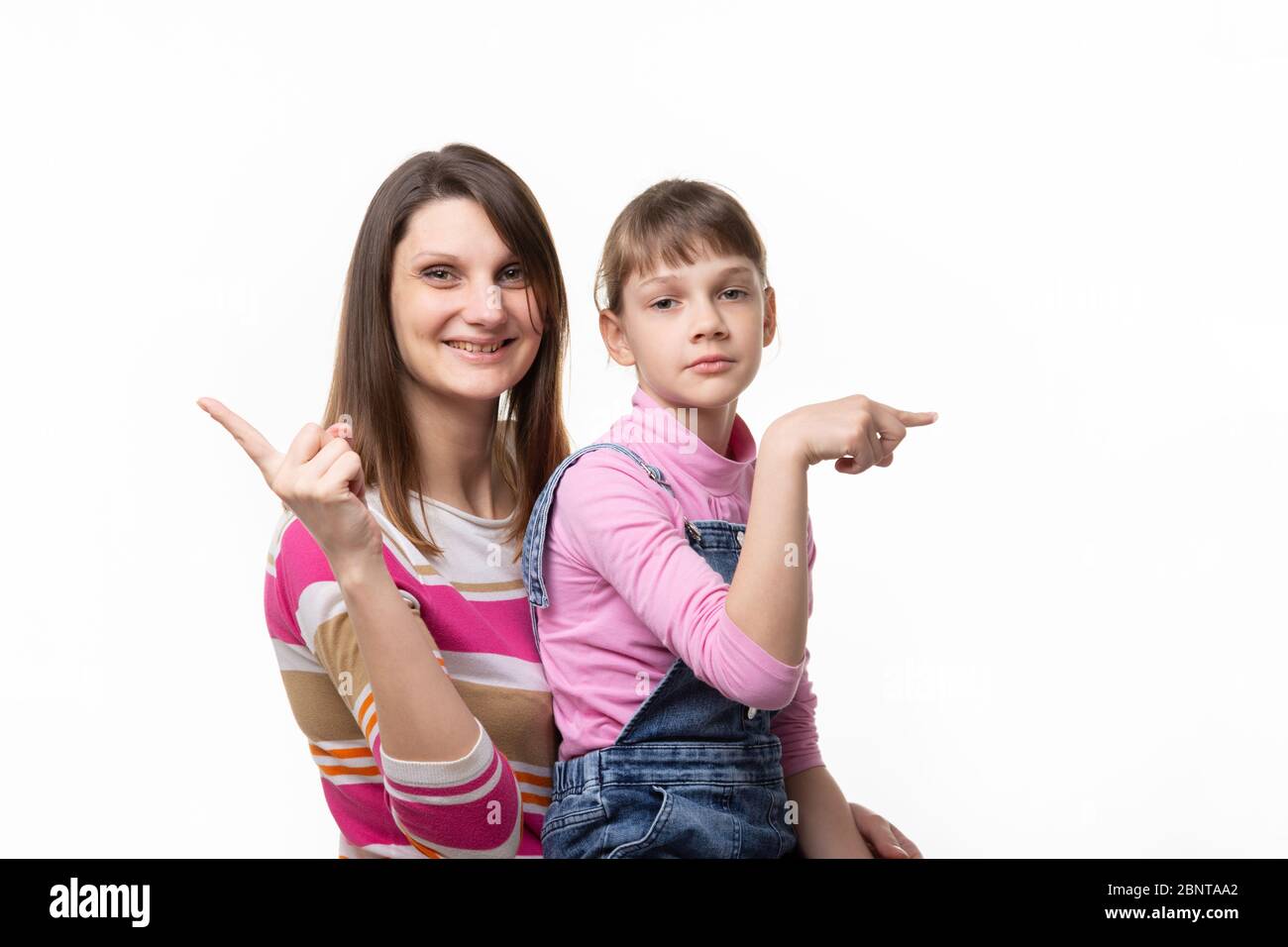 The girl joyfully points a finger in one direction, the girl is sad in ...