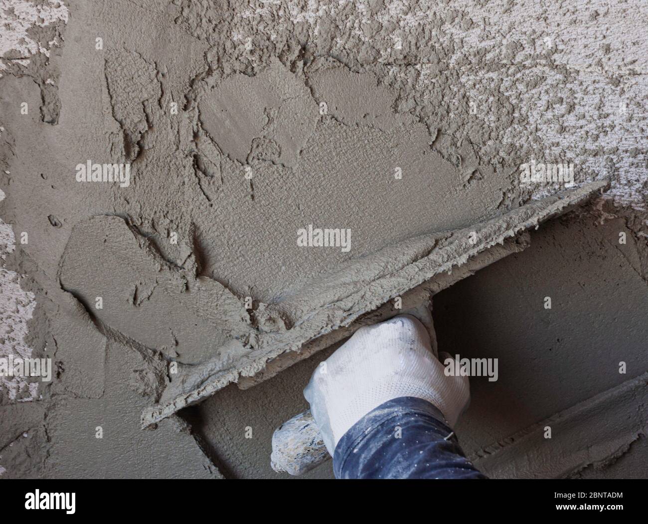 Worker plastering tool plaster marble on interior plaster rough Stock ...