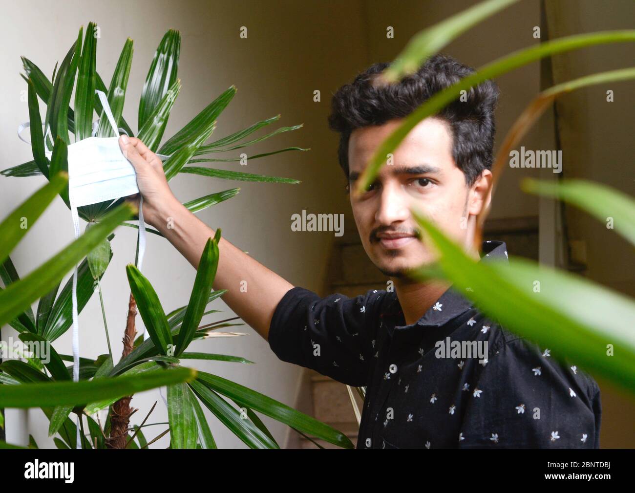 Man in garden holding face mask hi-res stock photography and images - Alamy