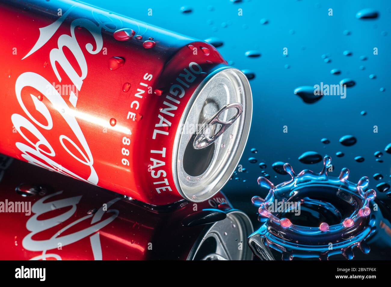Bedford,UK,May 16,2020. Coca Cola can with splashes of water on a black ...