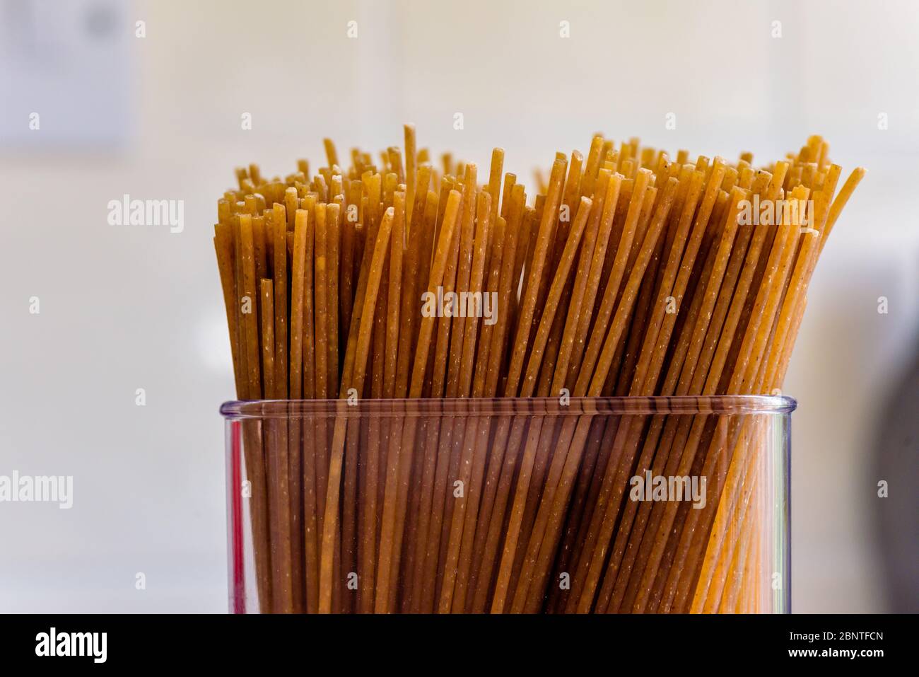 Yellow long spaghetti in container hi-res stock photography and images ...