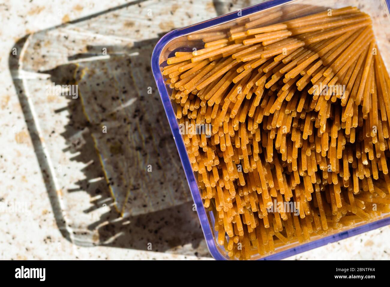 Yellow long spaghetti in container hi-res stock photography and images ...