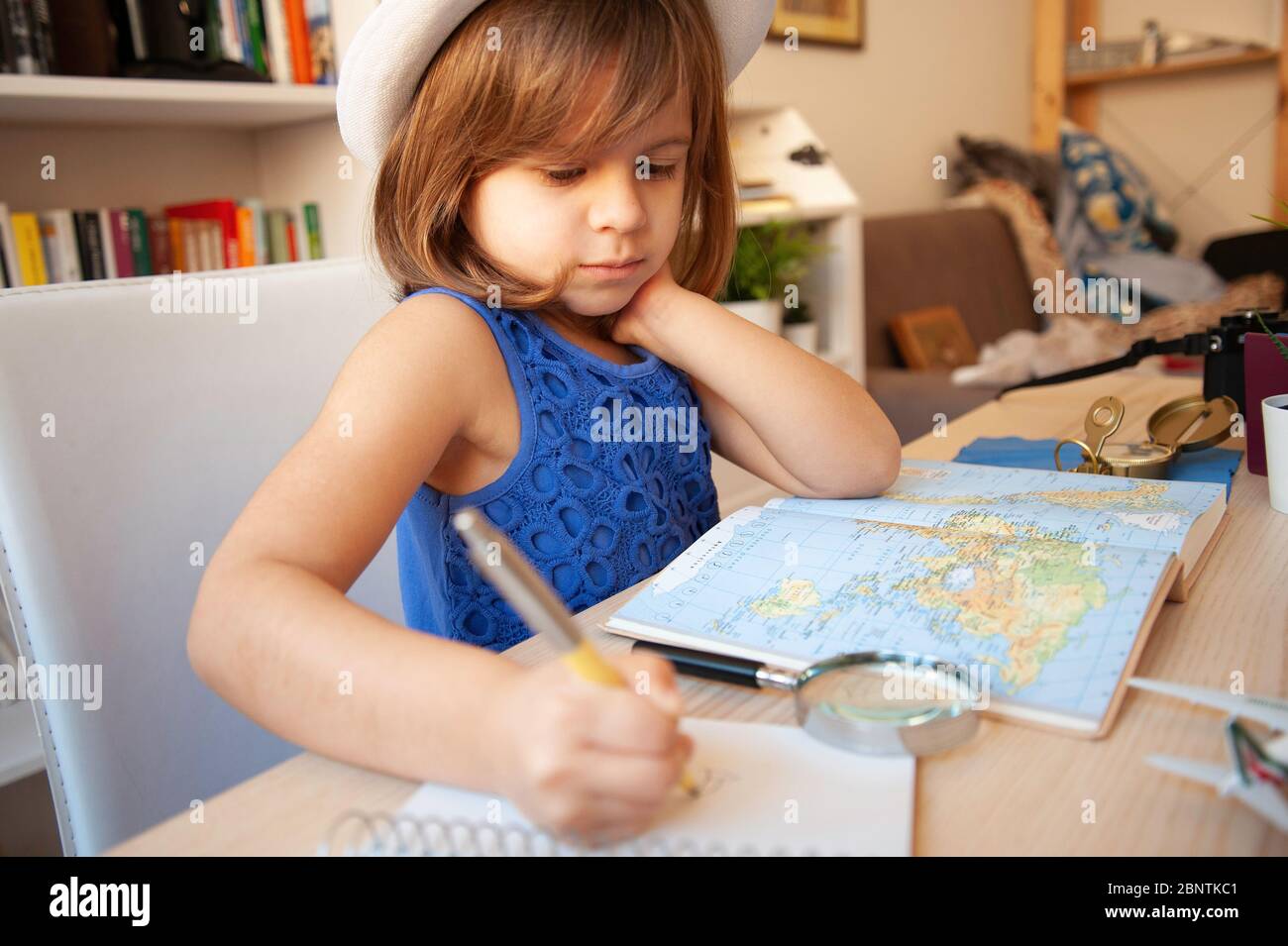 Trendy little girl in summer casual wear and white hat is doing ...