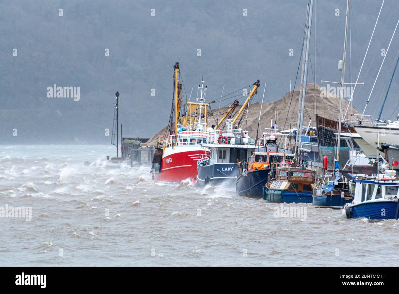 Fishing boats alongside the harbour wall at Port Penrhyn at Bangor in ...