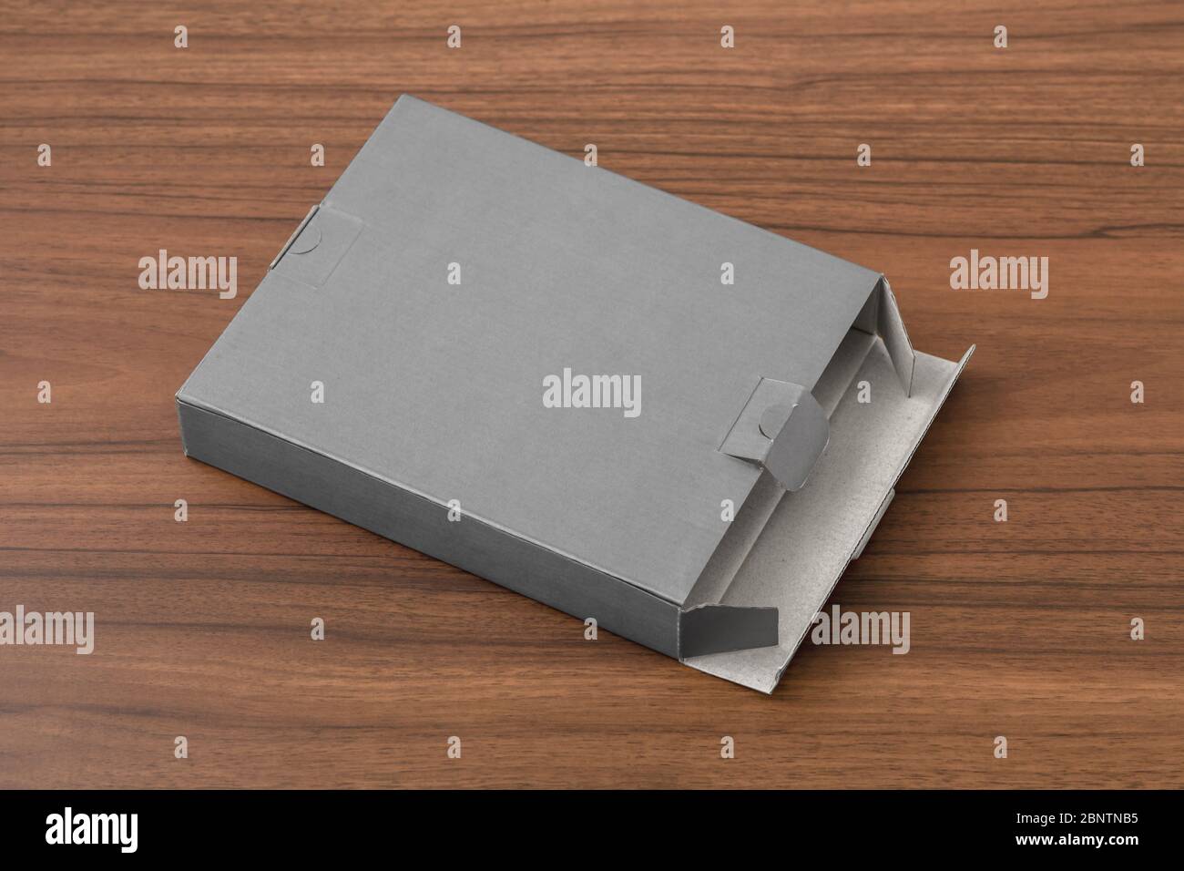 Open grey box packaging mockup on wood table Stock Photo - Alamy