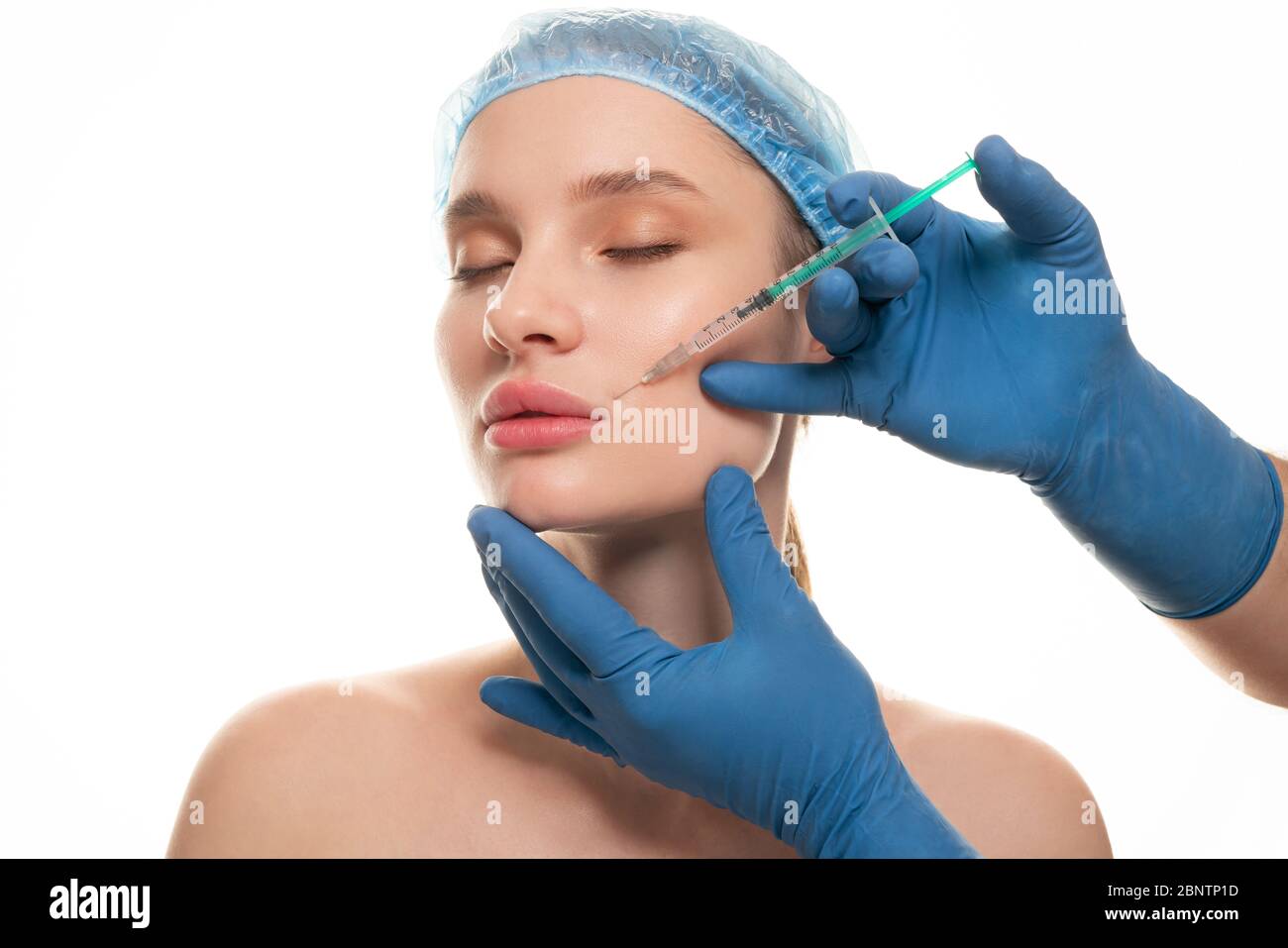 Portrait of young Caucasian woman getting cosmetic injection of botox ...