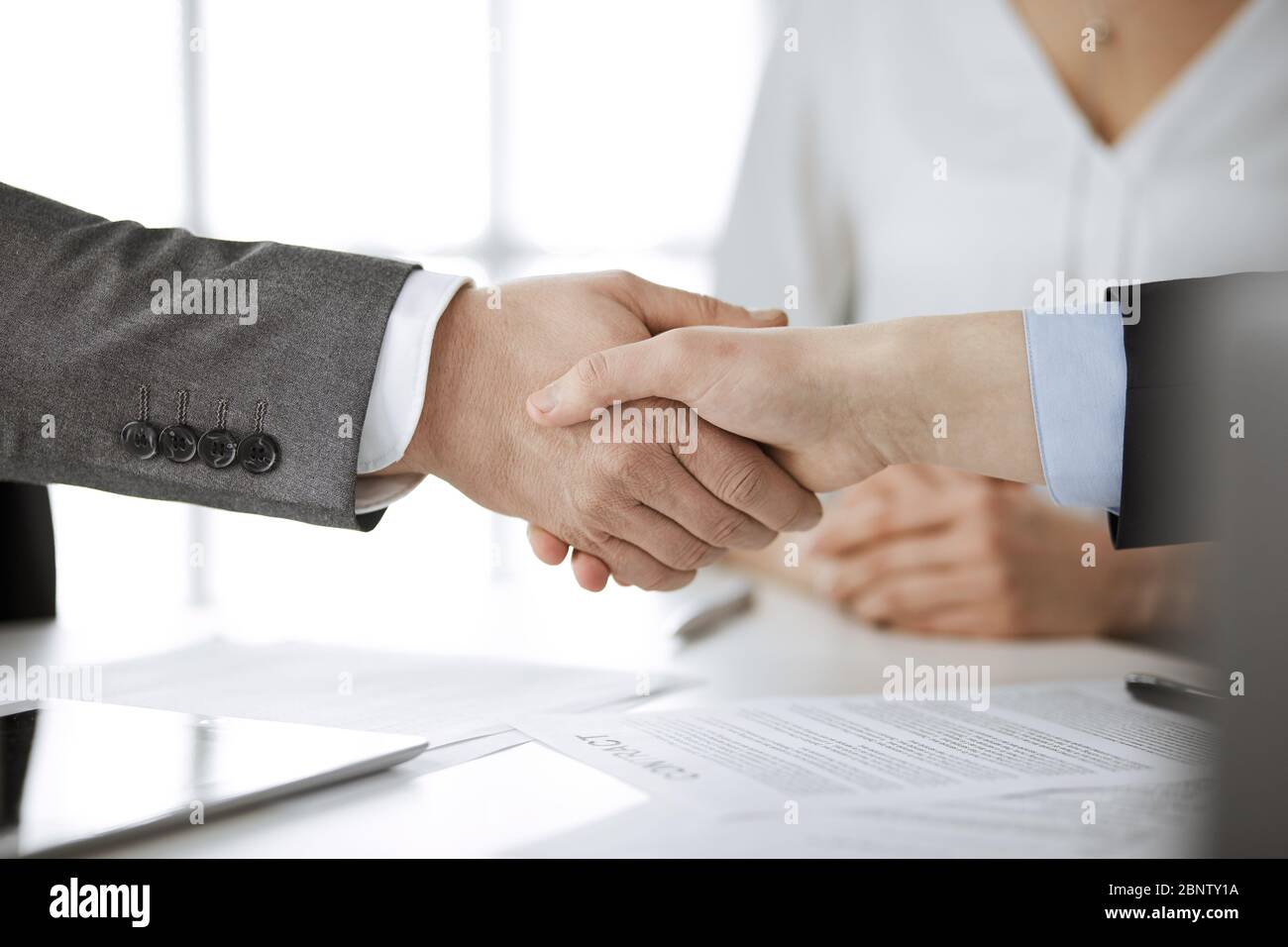 Business people shaking hands finishing contract signing, close-up ...