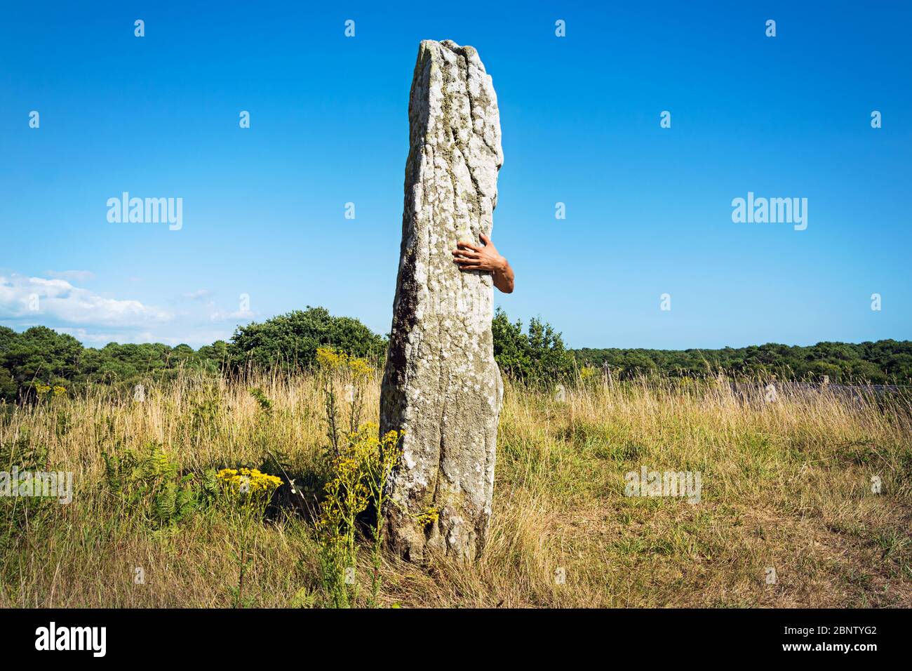 Standing stone hug Stock Photo - Alamy