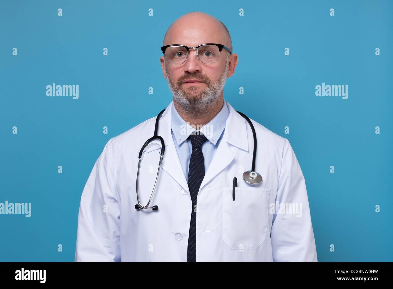 Serious Middle Aged Doctor in Scrubs and Labcoat with Stethoscope ...